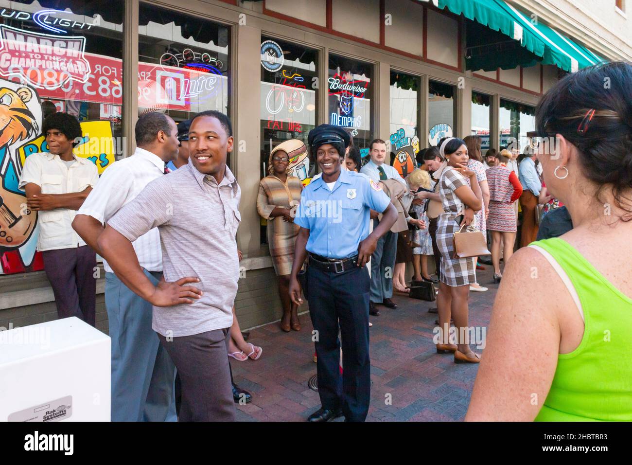 extras or background actors dressed as a cop in period 1970s clothes ...