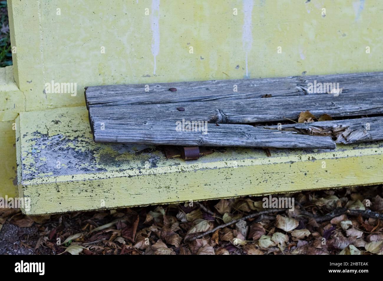 A ruined yellow concrete bench with a broken wooden seat (Pesaro, Italy ...