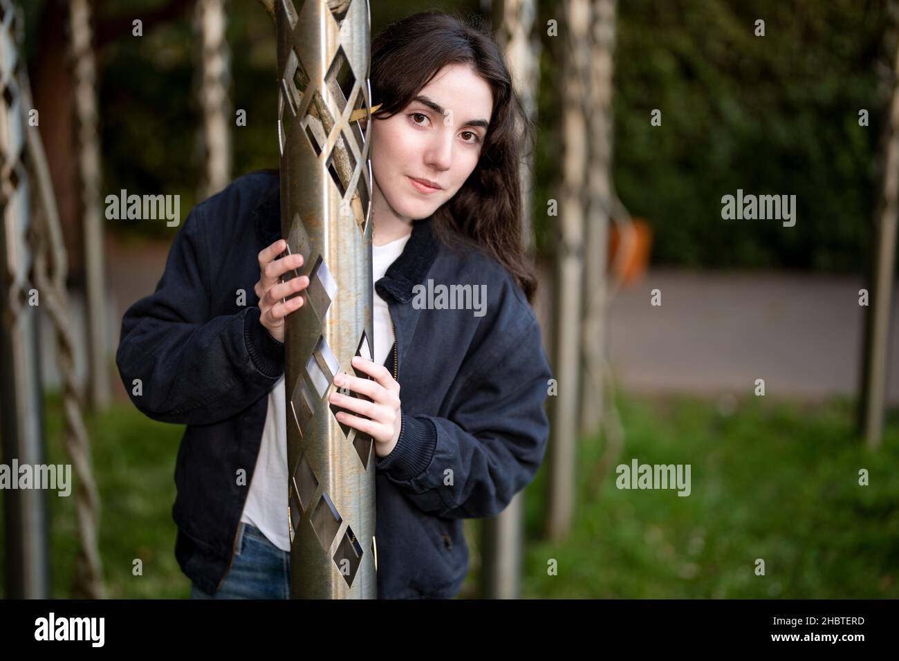 Teenage Woman Standing Holding Metal Poles Stock Photo - Alamy
