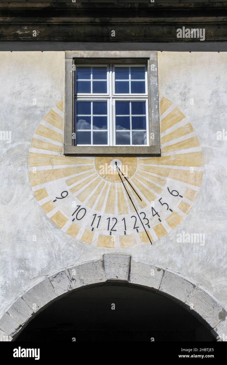 Ancient sundial on stone wall over the arch gate Stock Photo - Alamy
