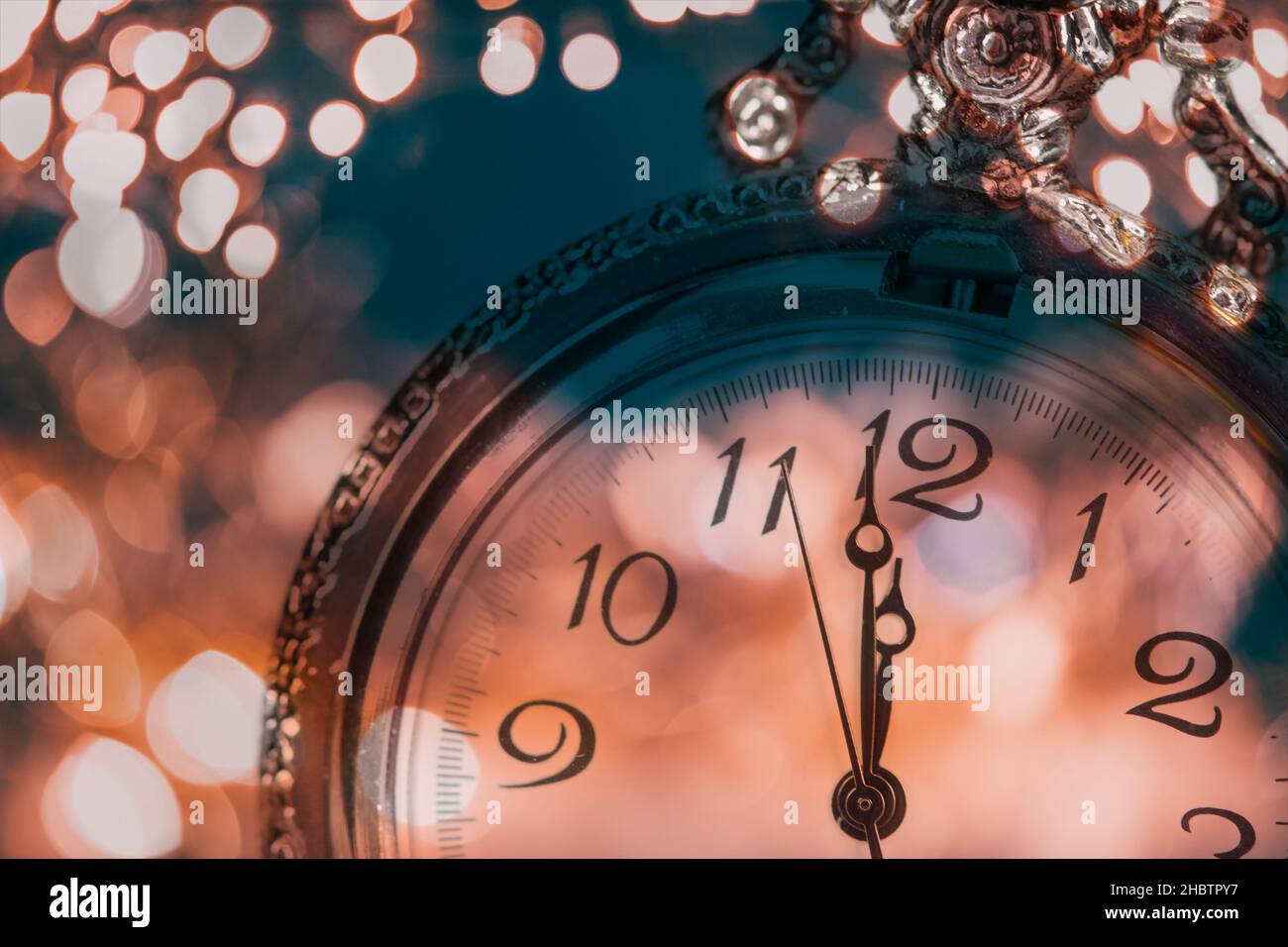 Clock close to midnight on sparkling holiday background Stock Photo - Alamy