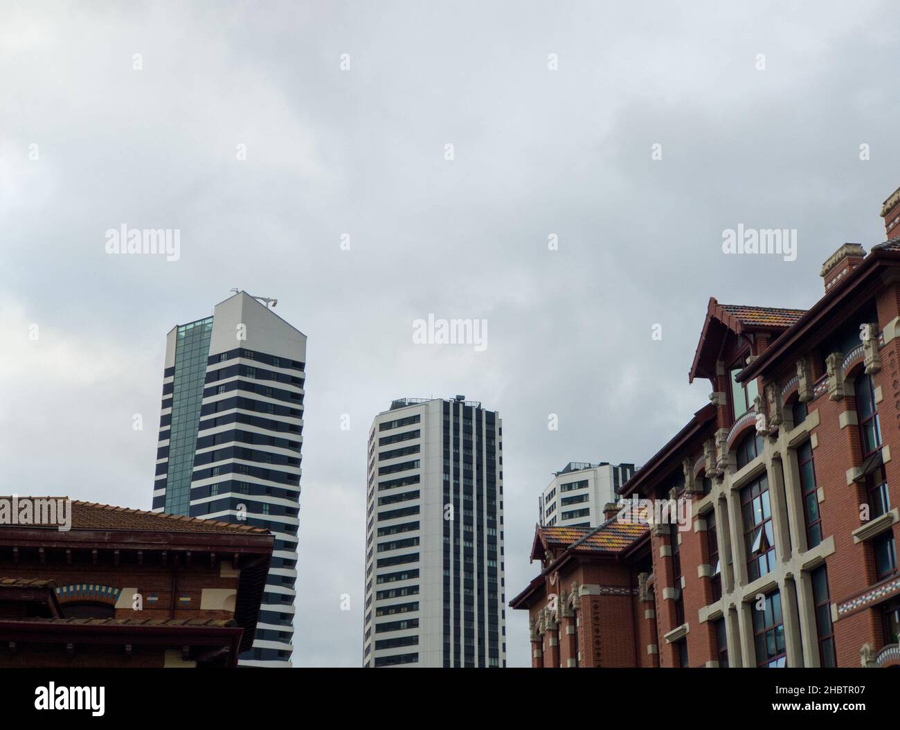 A gloomy autumn day with the clouds hovering over the tall buildings ...