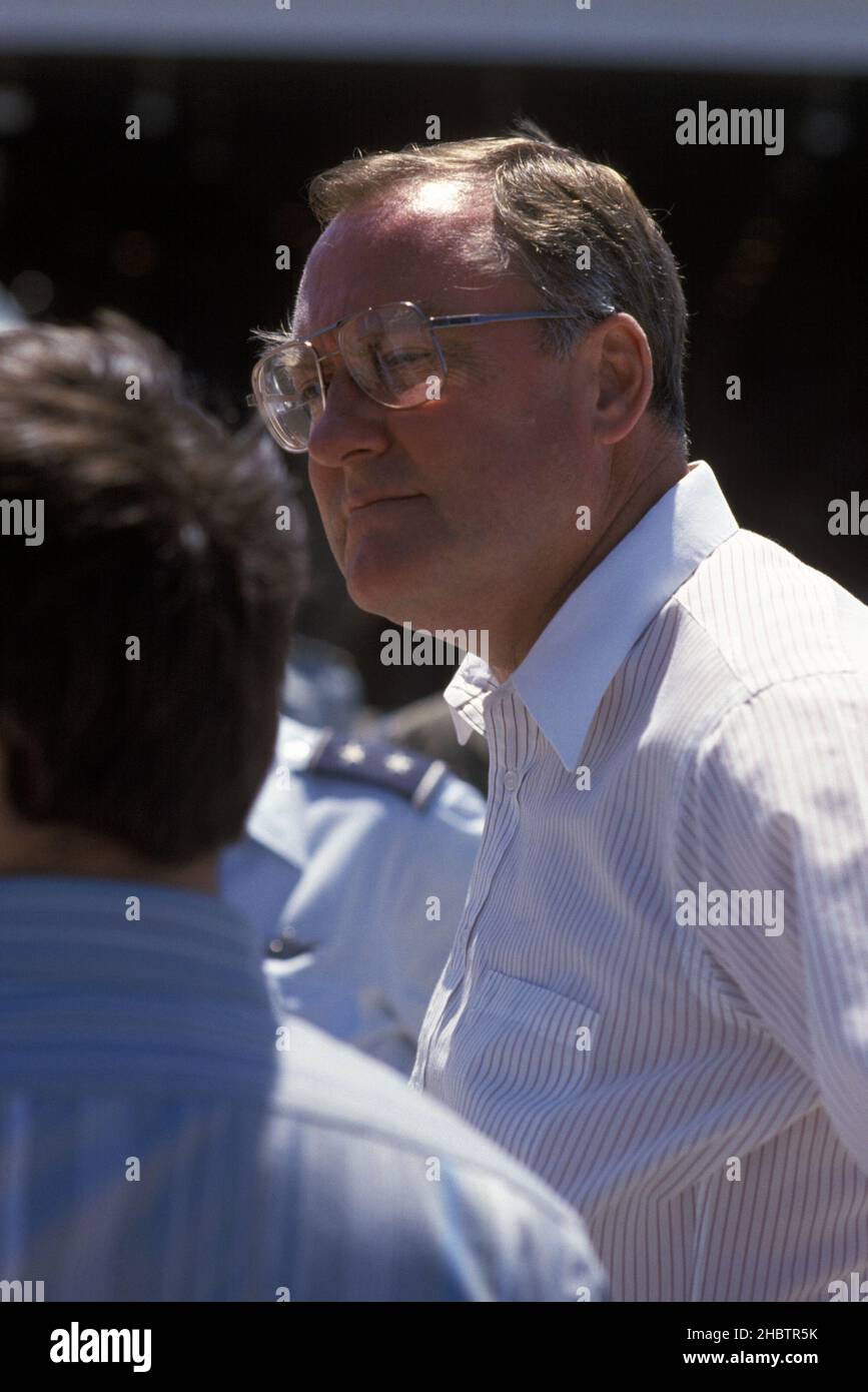 Illinois Governor James R. Thompson observes as bales of hay are loaded ...