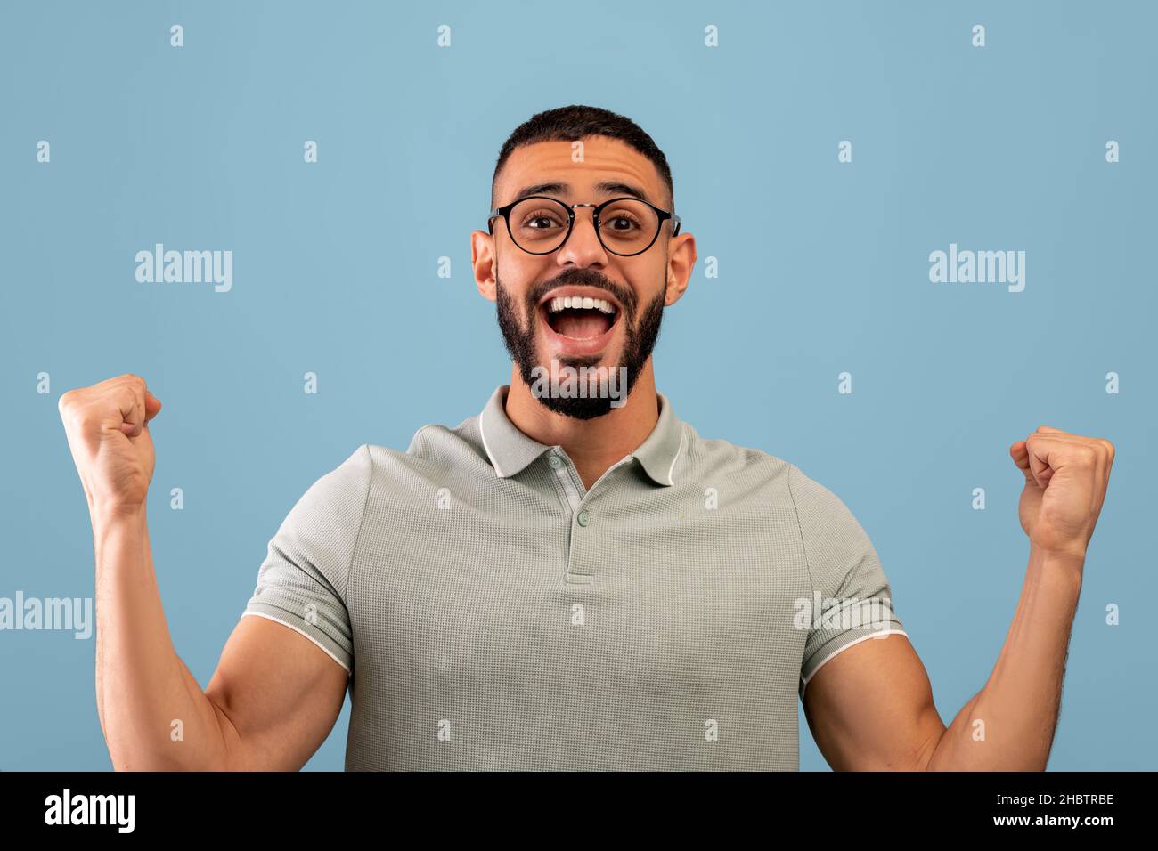 Satisfied happy arab man rejoicing to success and shouting in ...