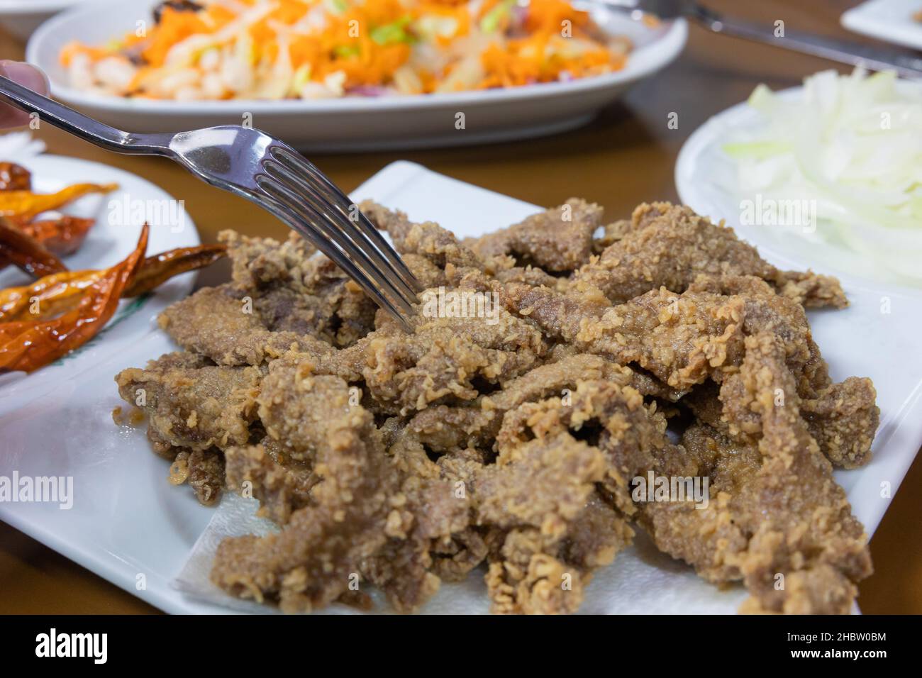 Edirne's fried liver or tava cigeri in Turkish with some appetizer on ...