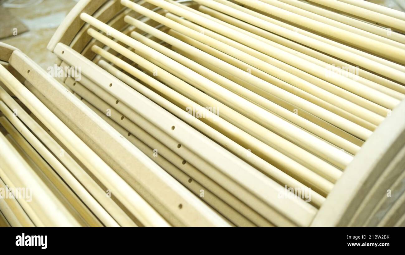 Unfinished wooden chair in ware house under skylight. Furniture factory ...