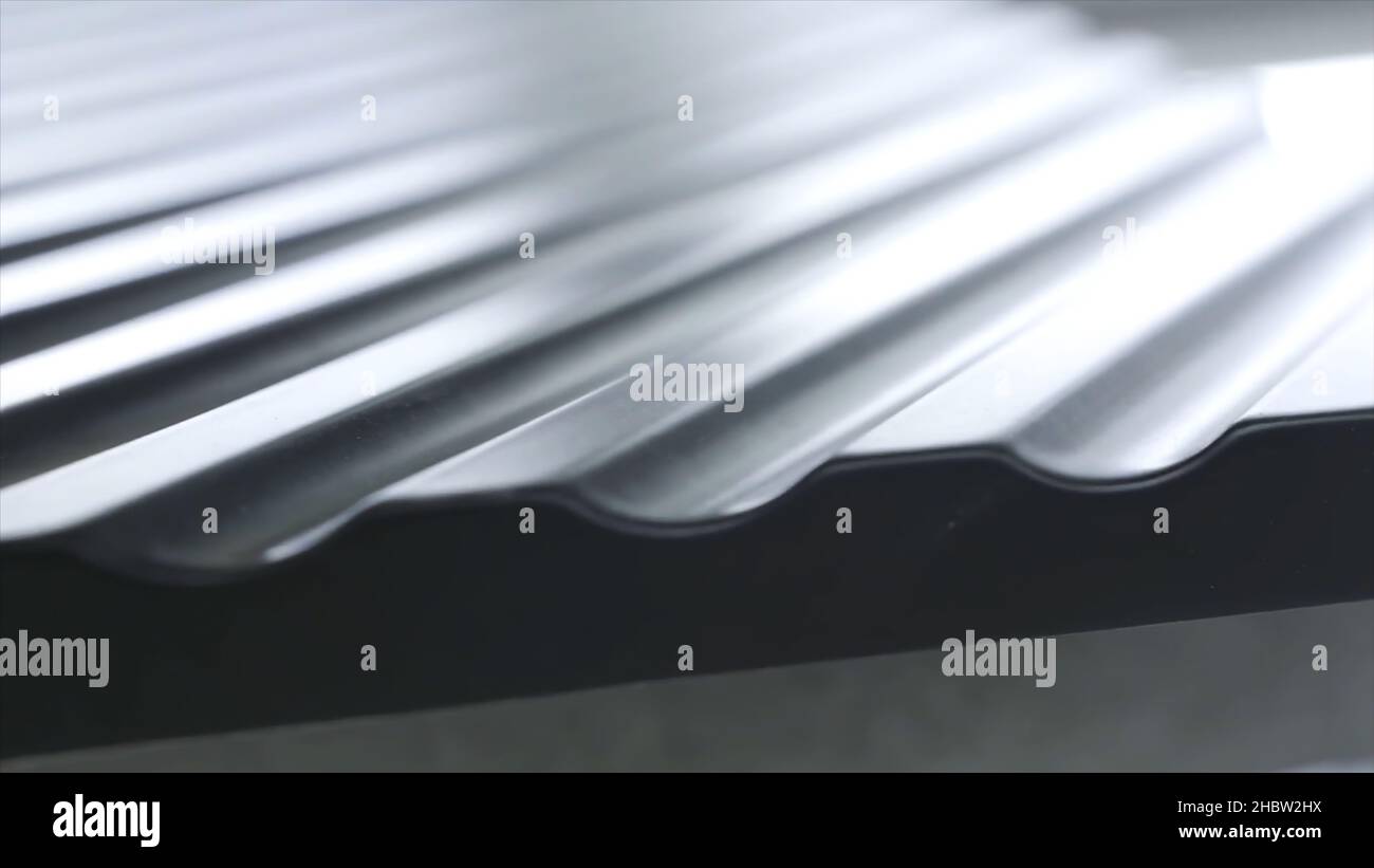 Close up side of black wavy roof tiles on blurred background. Black ...