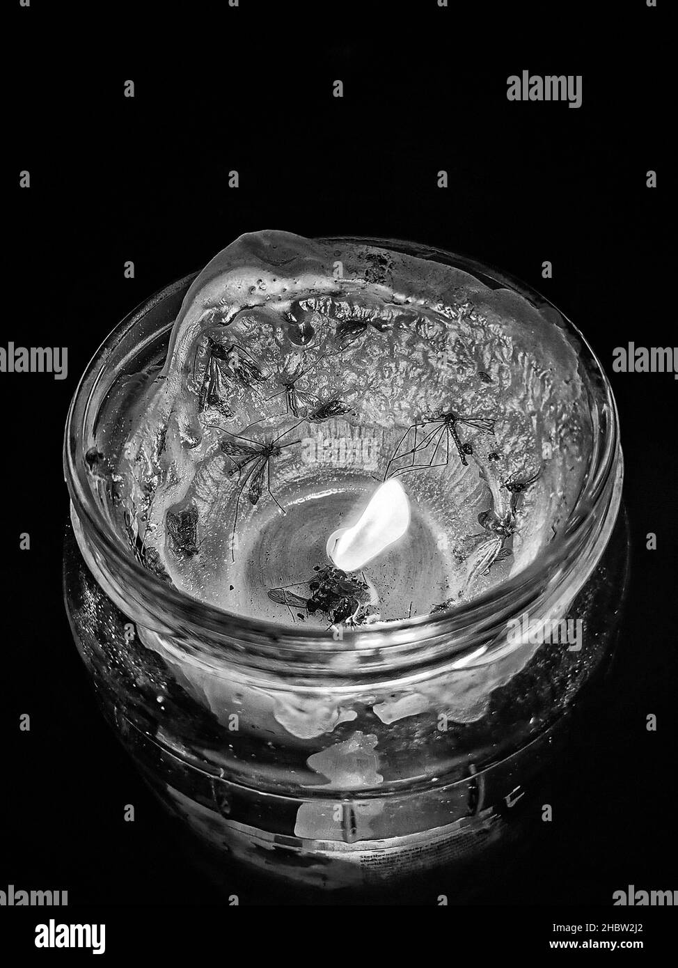 A grayscale of an abstract candle burning in a darkness Stock Photo - Alamy