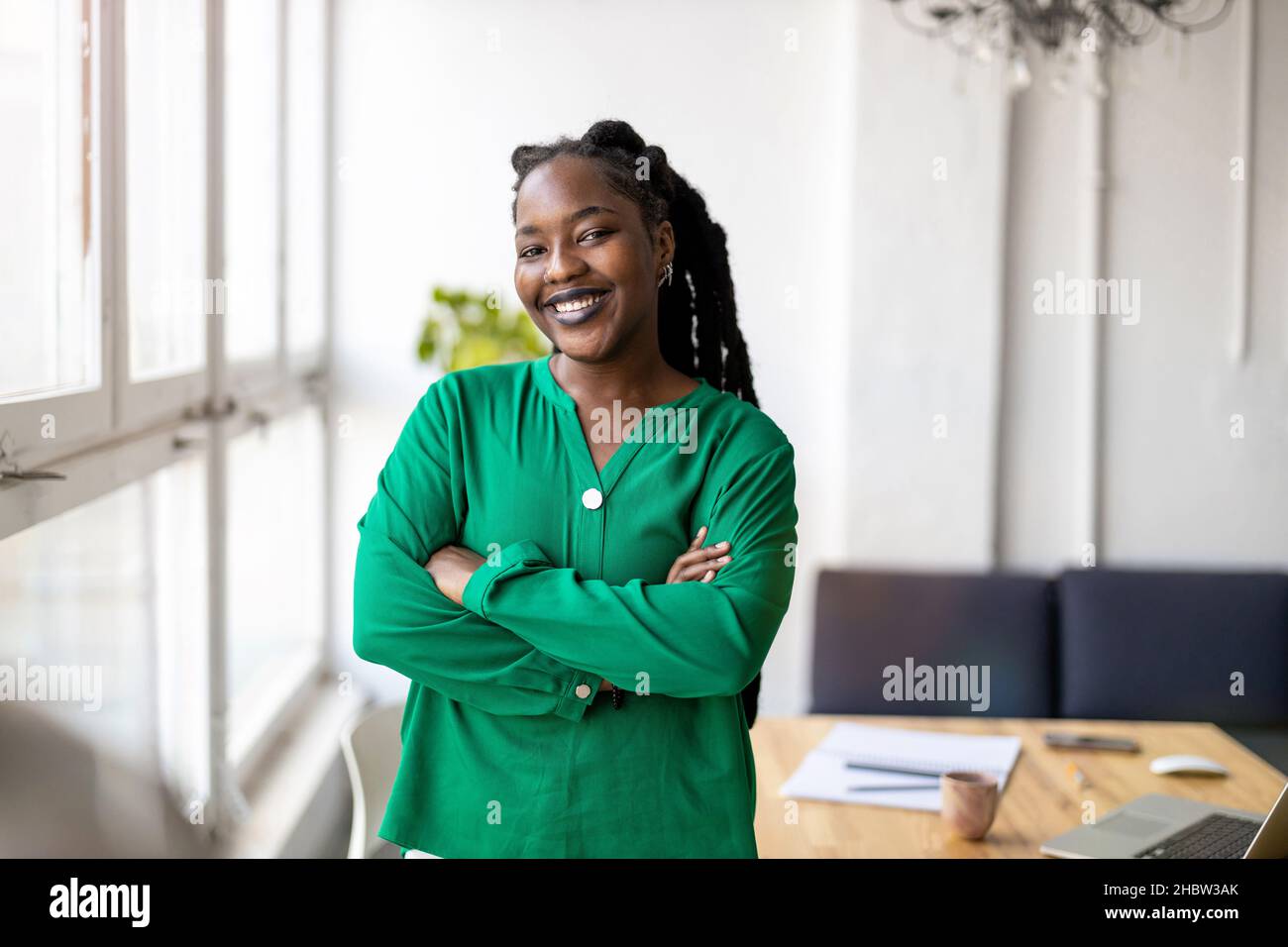 Portrait of a smiling creative woman in a modern loft office Stock ...