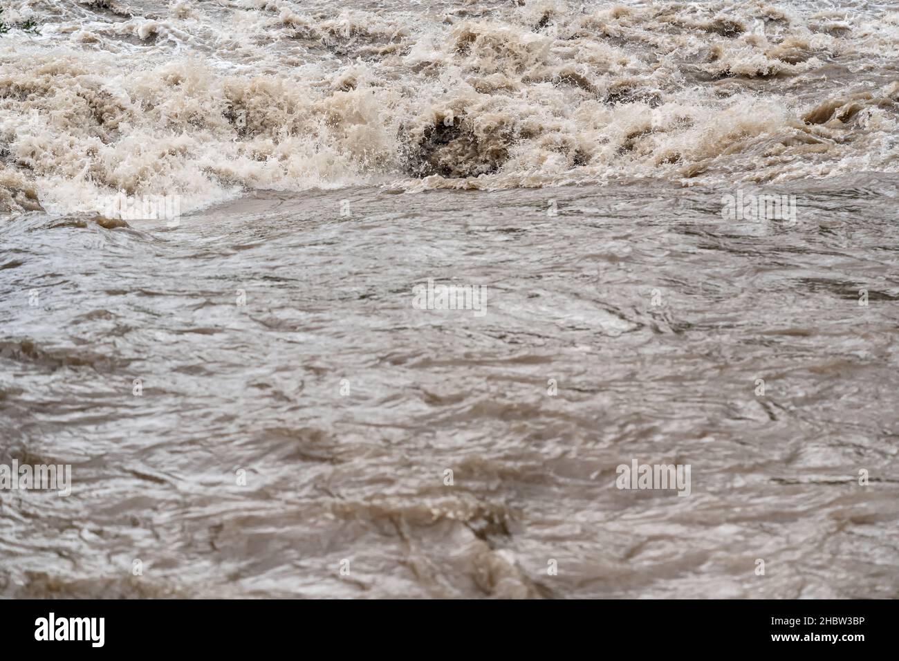 Dirty flood water flowing rapidly in river Stock Photo - Alamy