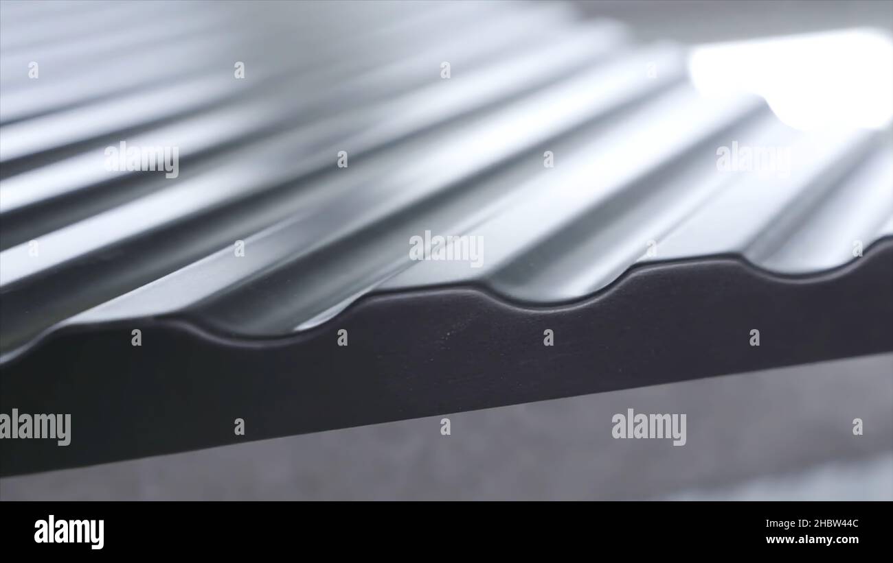 Close up side of black wavy roof tiles on blurred background. Black ...