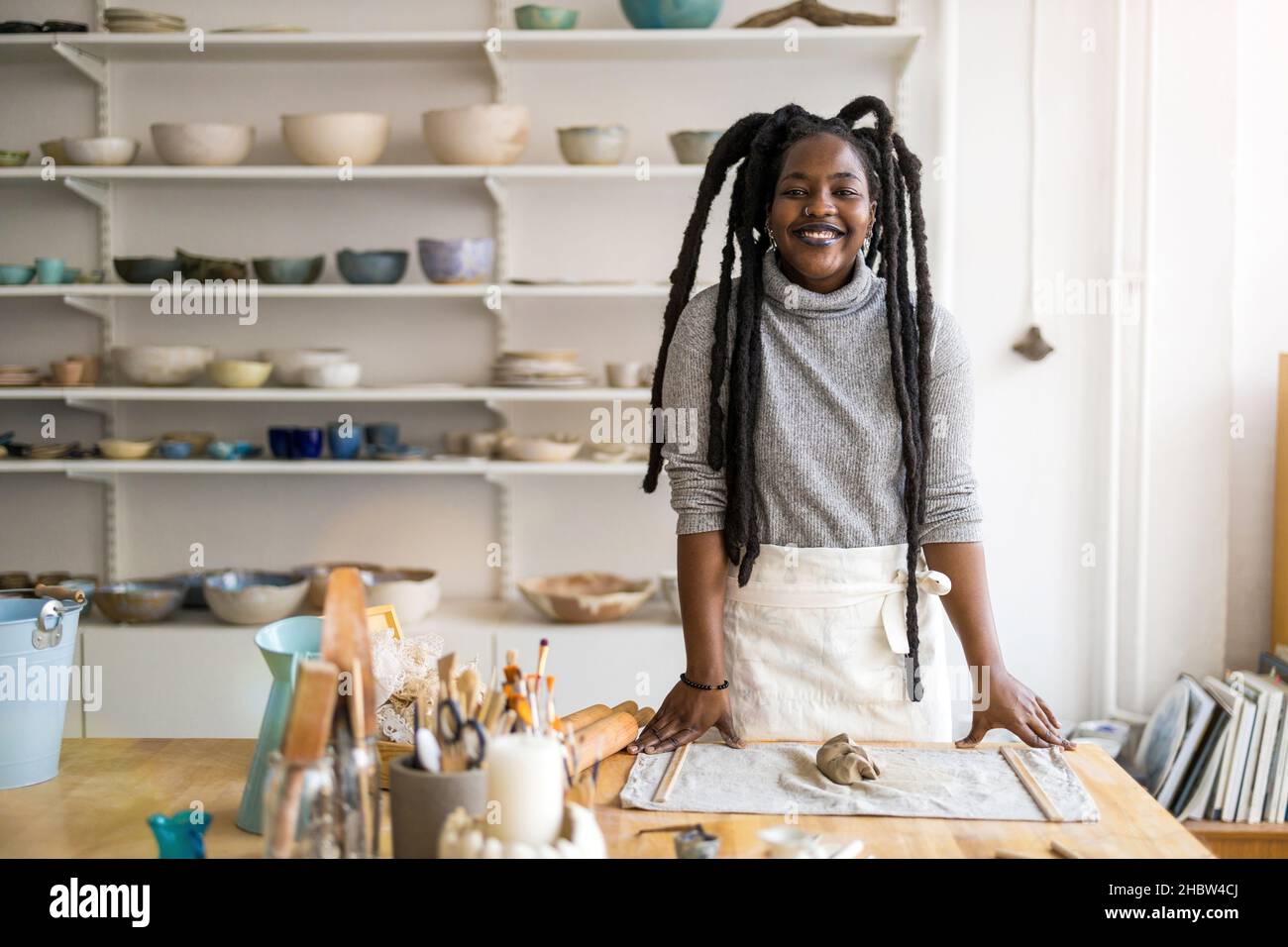 Woman pottery artist working in her art studio Stock Photo - Alamy