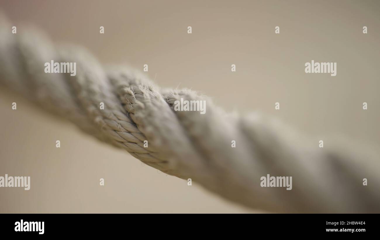 Extreme close up of a rope on blurred beige background. Macro view of a ...