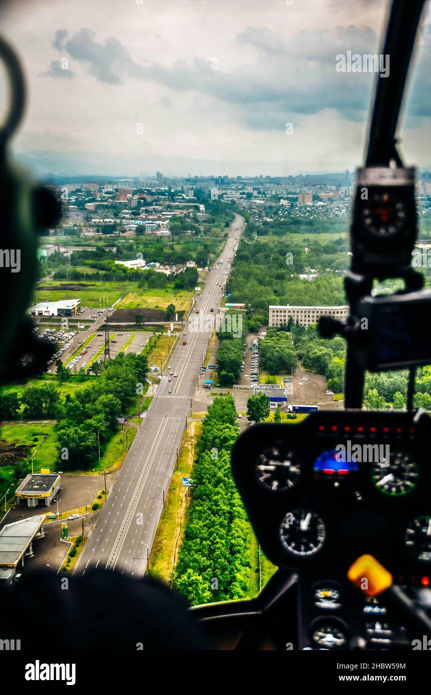 Close up of a helicopter pilot flying aircraft over a city. High ...