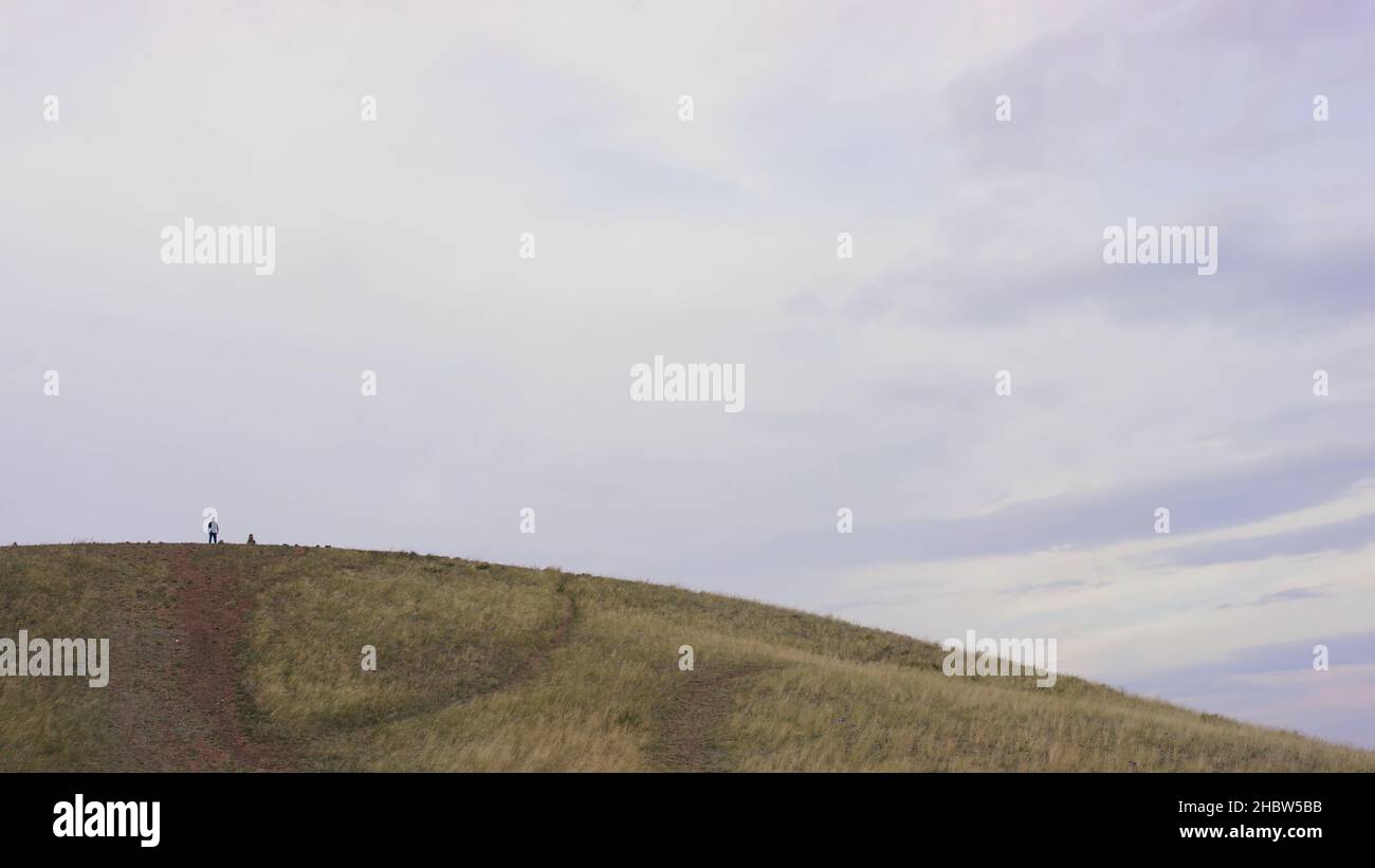 Rear view of man standing on the hill. Back view of man looking at ...