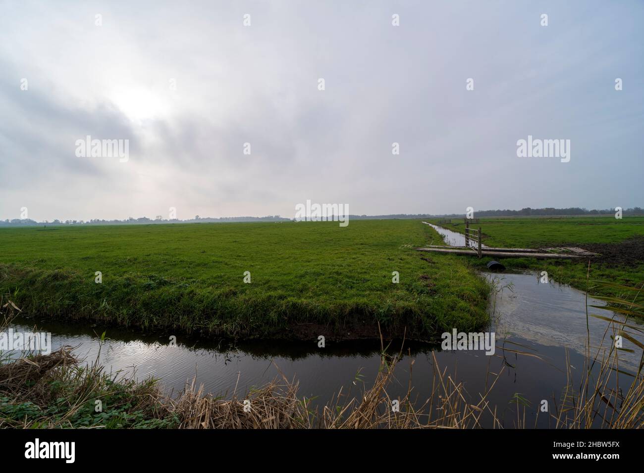 Landscape picture of a ditch and farmlands Stock Photo - Alamy