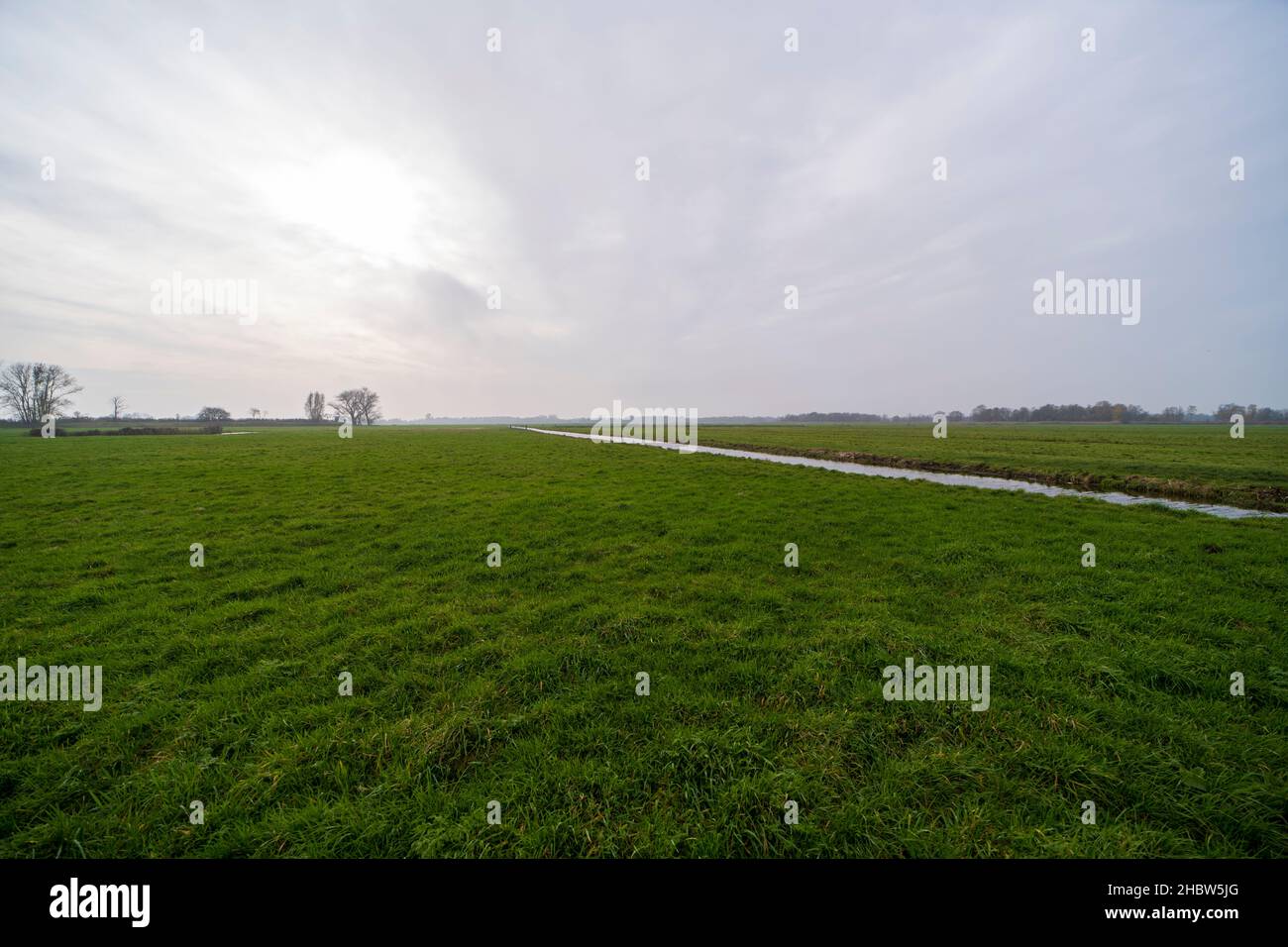 Landscape picture of a ditch and farmlands Stock Photo - Alamy