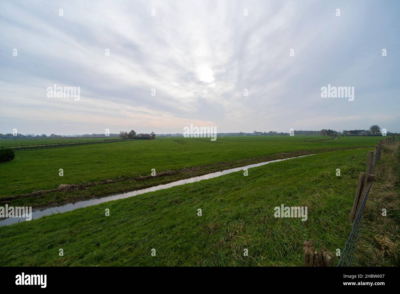 Landscape picture of a ditch and farmlands Stock Photo - Alamy