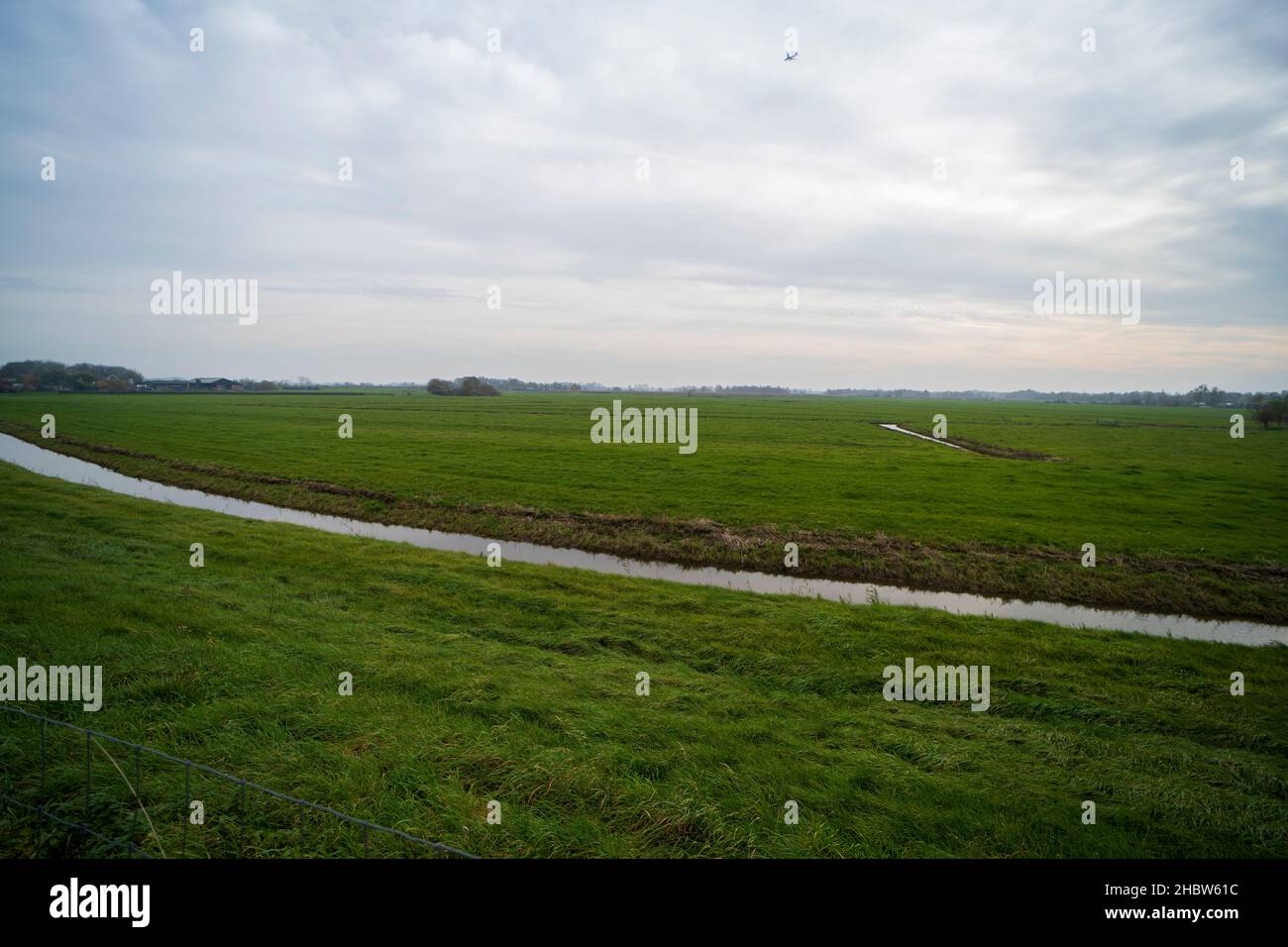 Landscape picture of a ditch and farmlands Stock Photo - Alamy