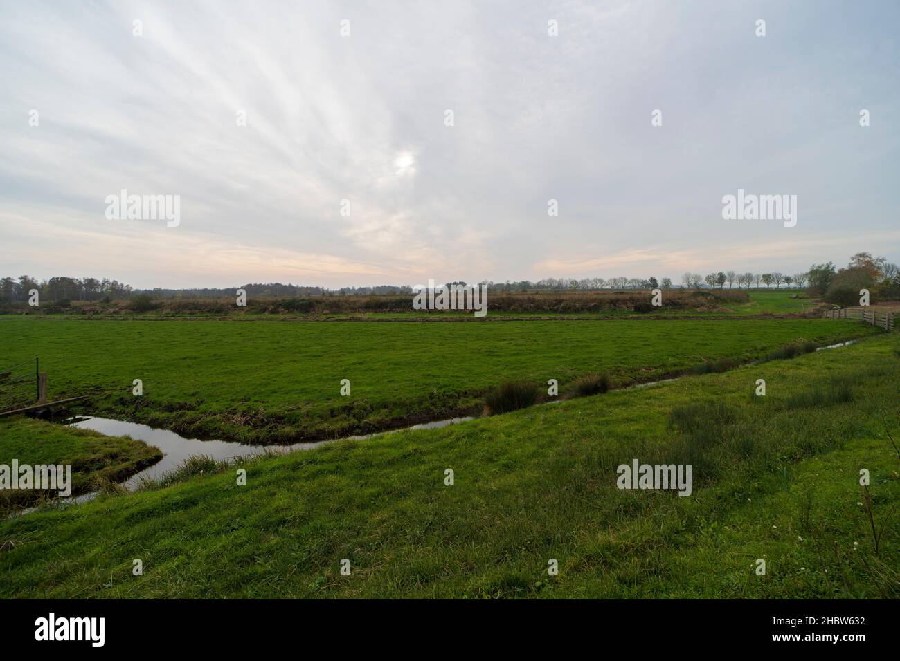 Landscape picture of a ditch and farmlands Stock Photo - Alamy