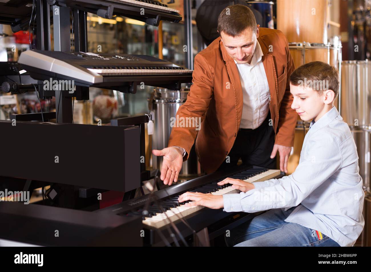 Seller shows the teen keyboard Stock Photo - Alamy