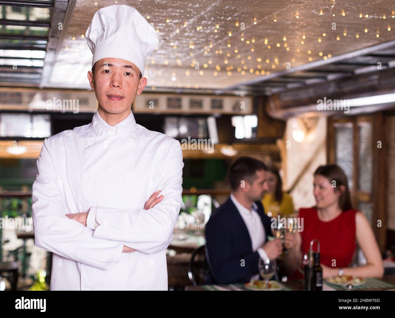 Smiling chef cook is posing in hall Stock Photo - Alamy