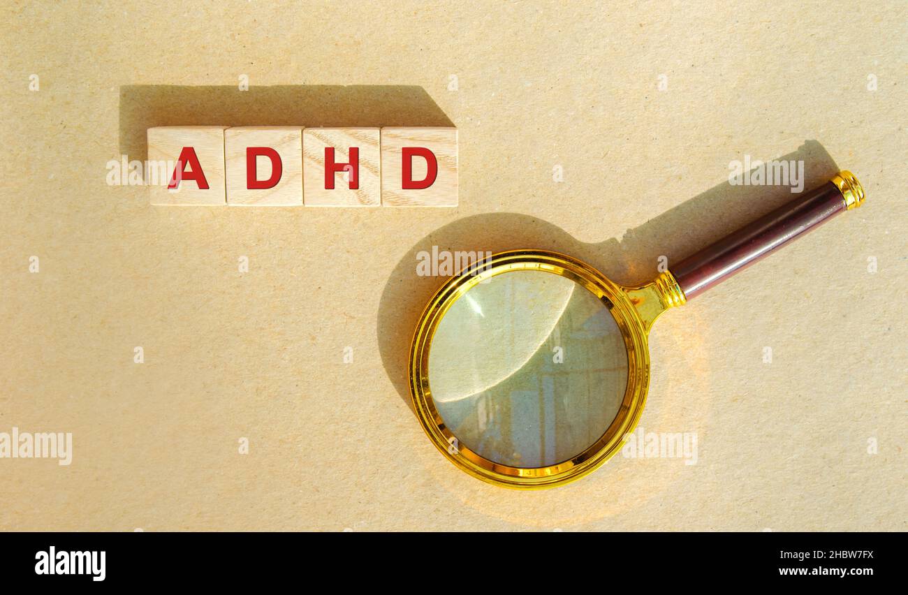 Wooden blocks ADHD and magnifying glass. Attention deficit ...