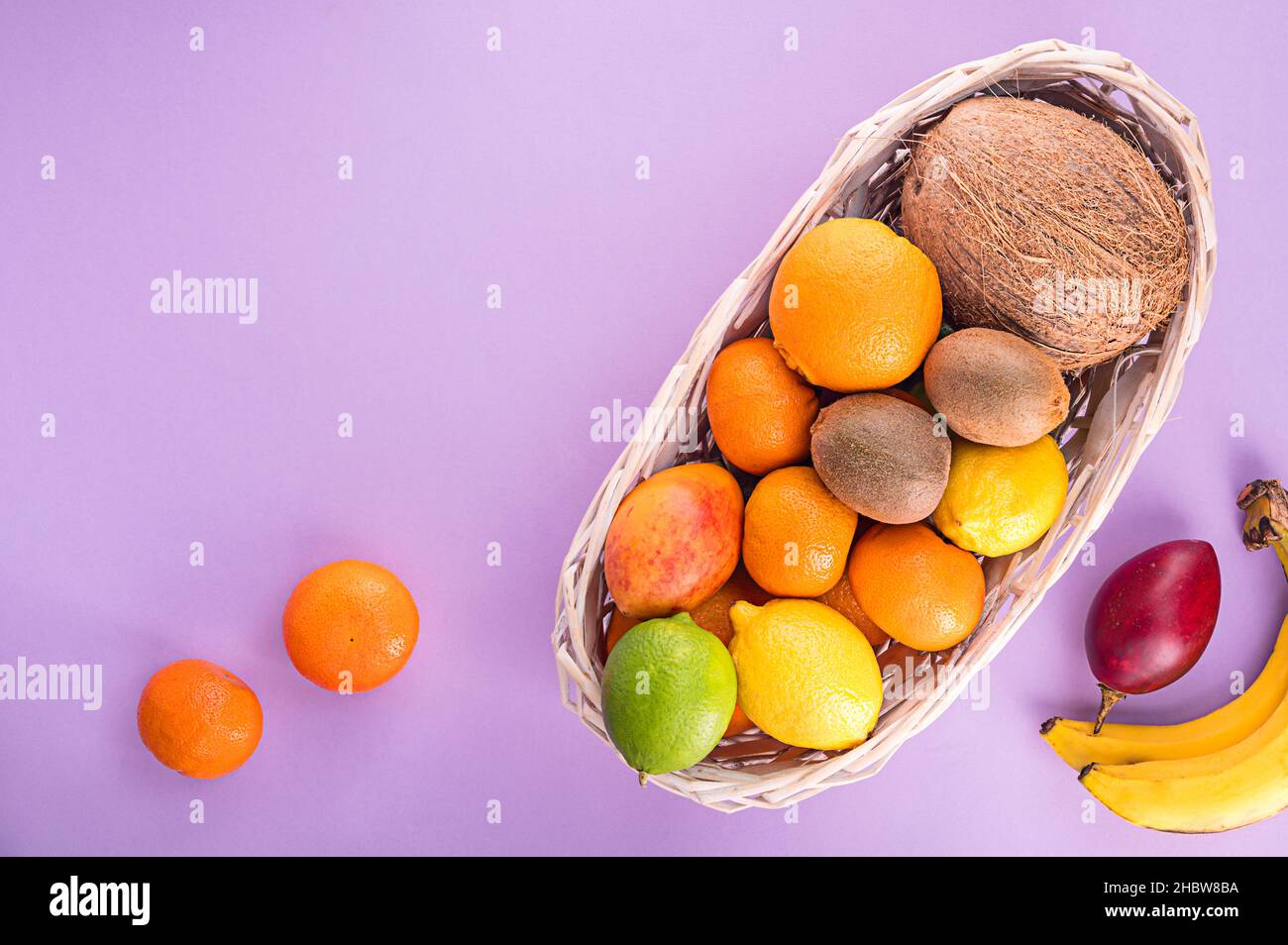 Citrus fruits in oval basket on purple background. Assorted citrus ...