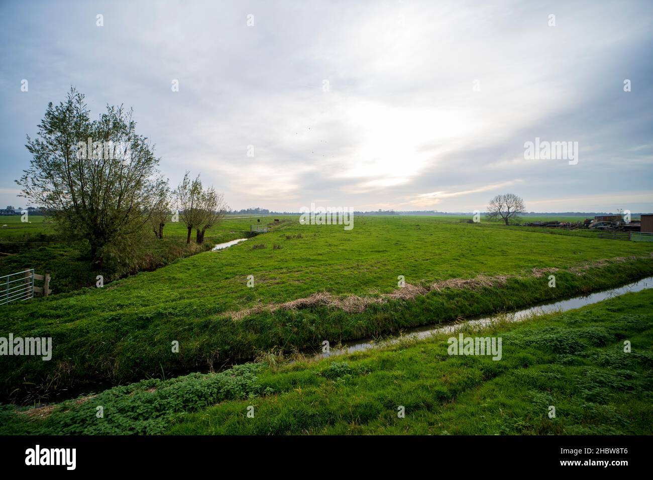 Landscape picture of a ditch and farmlands Stock Photo - Alamy