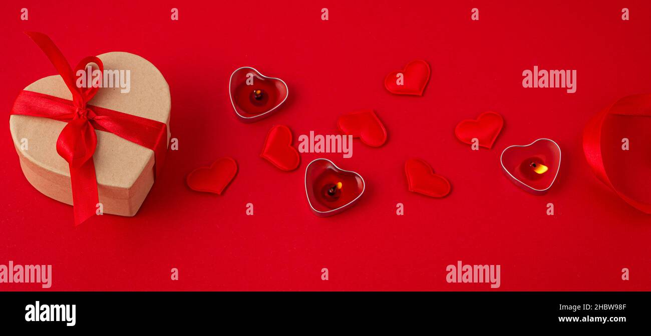 Saint Valentine top view composition with gift box, candles, hearts on ...