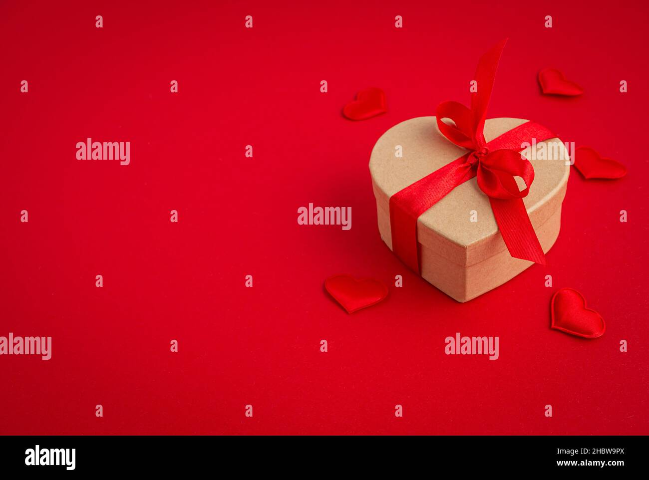 Gift boxe in heart shape with bow on red background, Saint Valentine ...