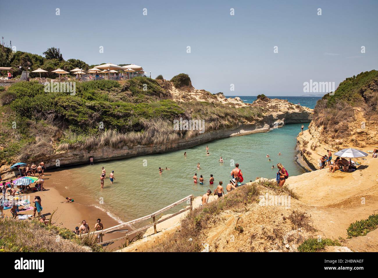Sidari, Corfu, Greece - August 01, 2021: People swim and sunbath in ...