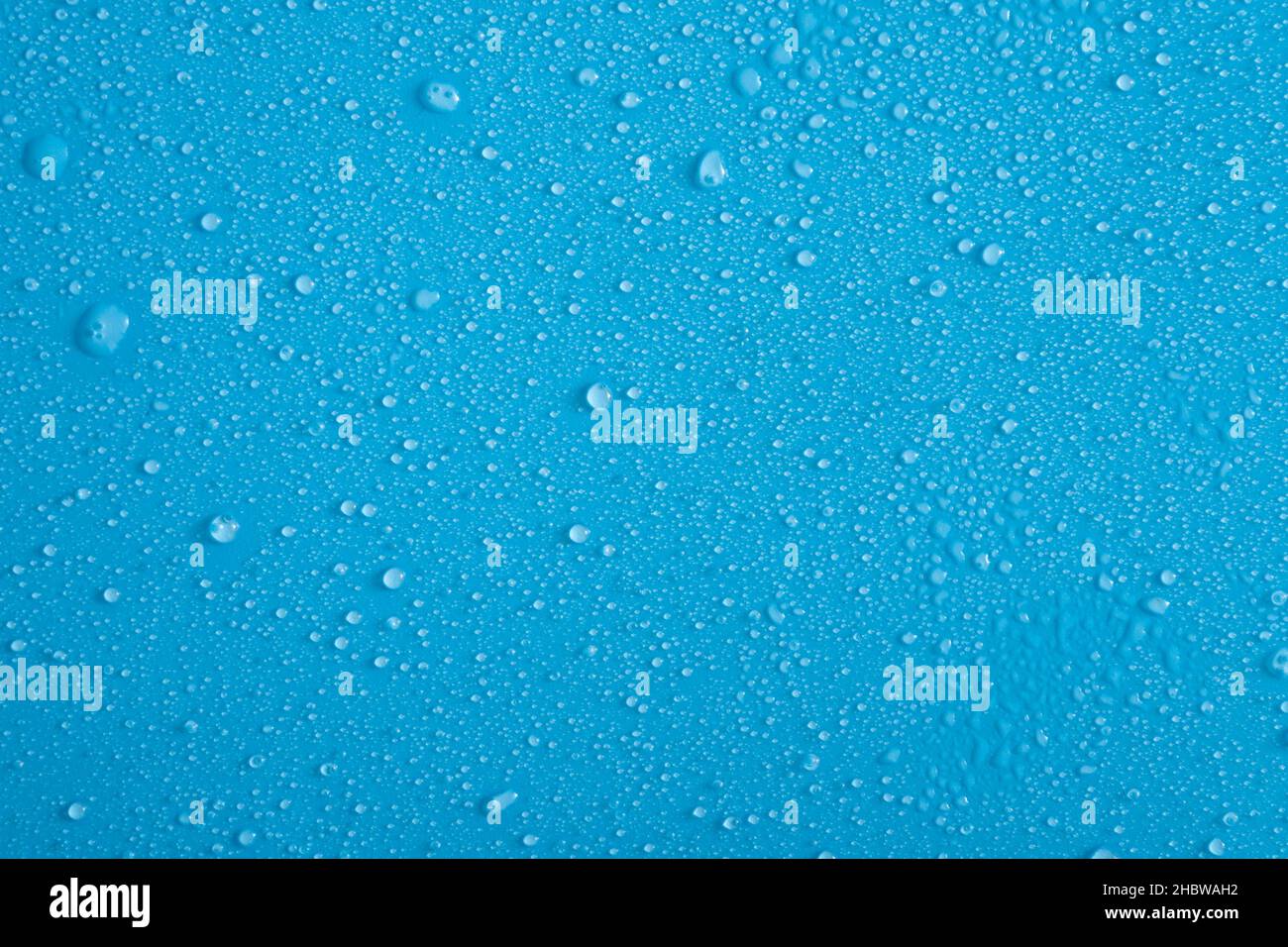 Full frame backdrop of water droplets splatter on blue background Stock ...