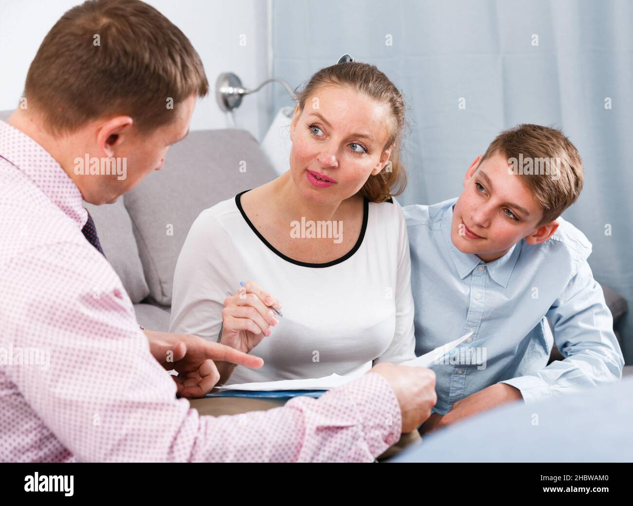 Mother and son signing documents Stock Photo - Alamy