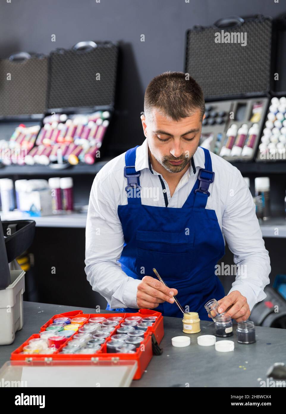 Mechanic selecting color for automobile upholstery Stock Photo - Alamy