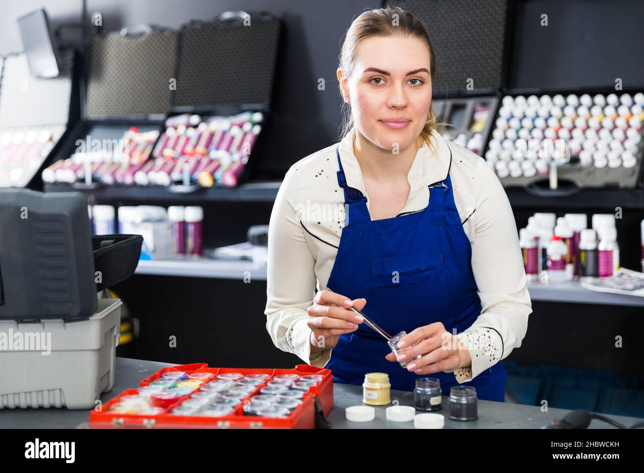 Female mechanic selecting color for automobile upholstery Stock Photo ...