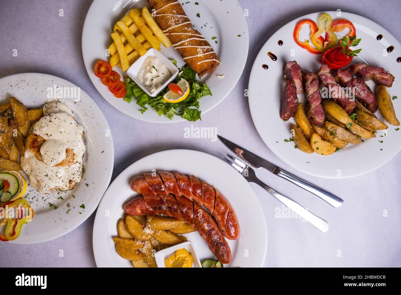 A top view of different dishes on a white table Stock Photo - Alamy