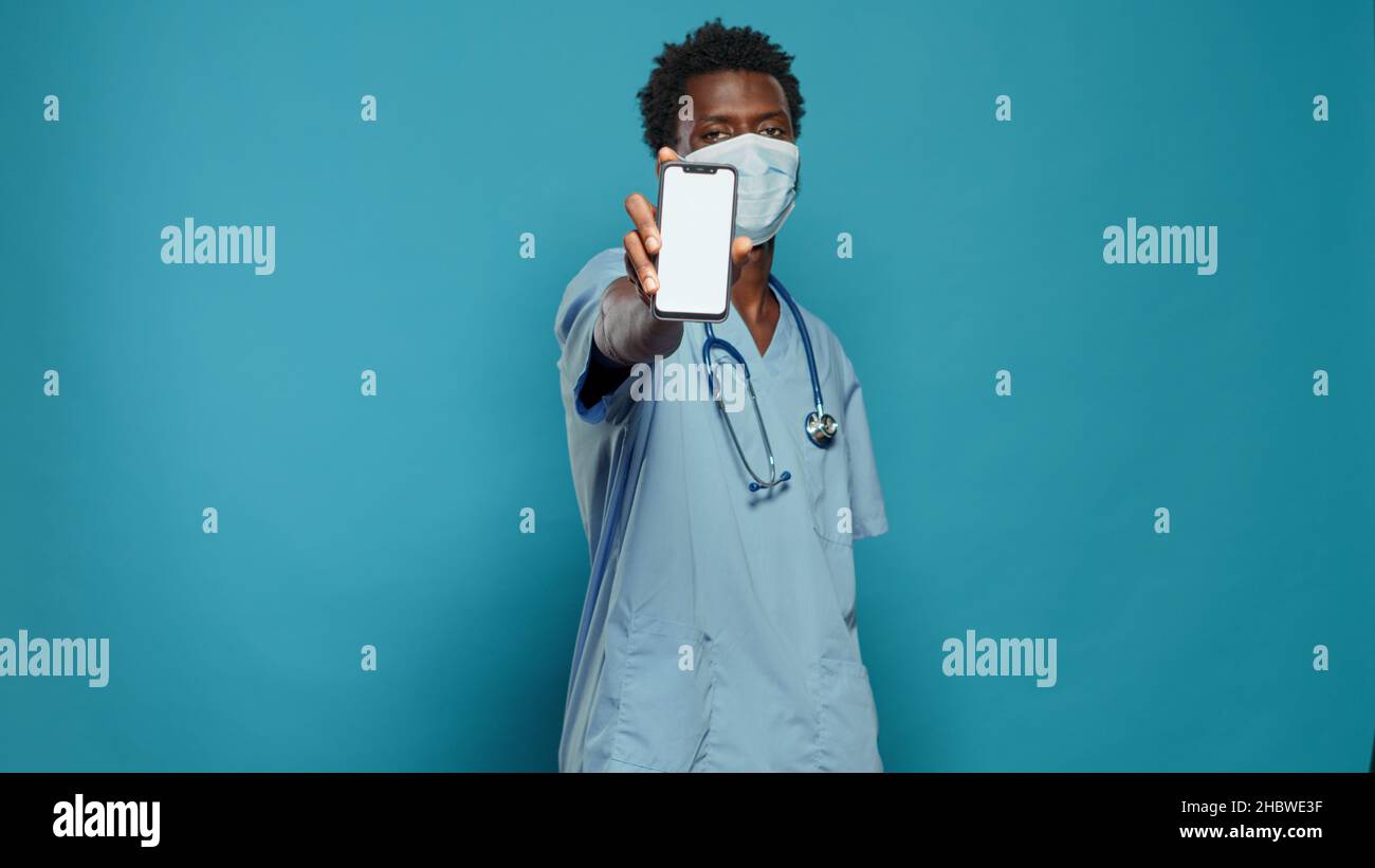 Medical assistant wearing face mask to protect from virus, showing ...
