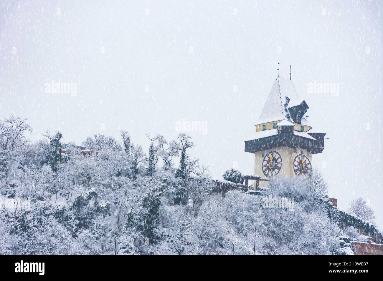 Heavy snow and the famous clock tower on Schlossberg hill, in Graz ...