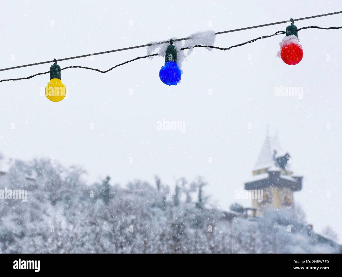 Heavy snow and the famous clock tower on Schlossberg hill, in Graz ...