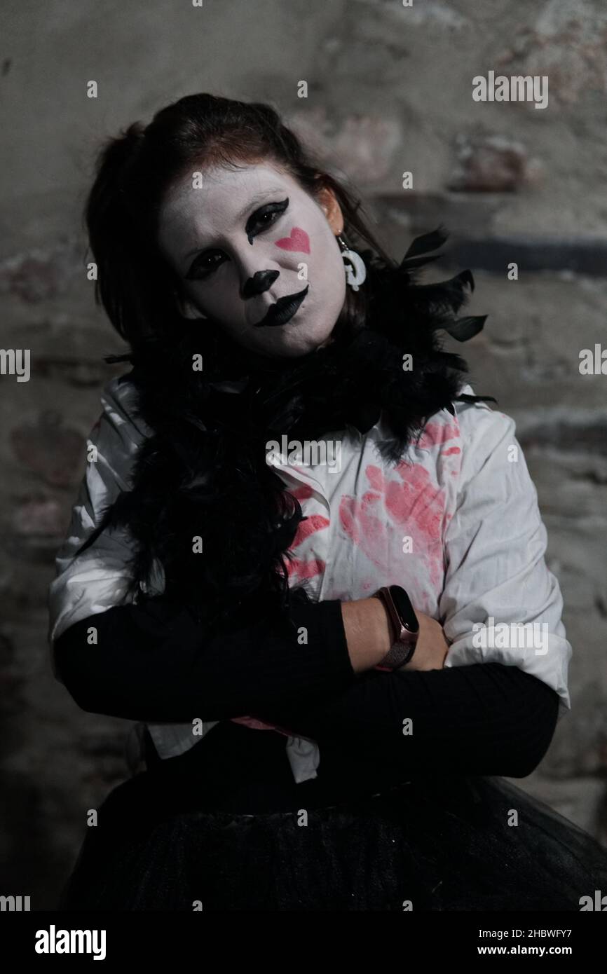 A young person in a bloody mime costume posing scarily Stock Photo - Alamy