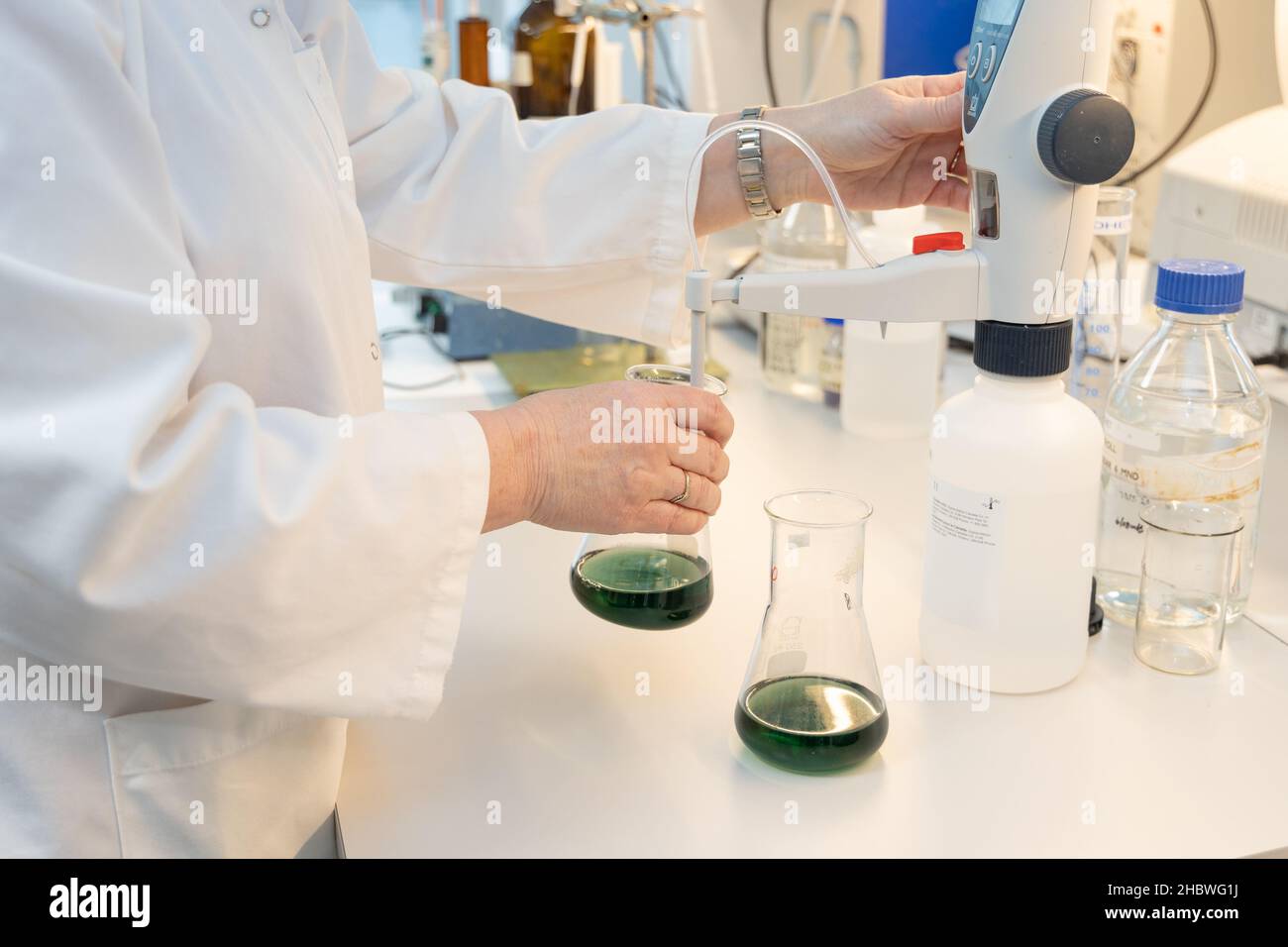 A scientist mixing liquids at the lab Stock Photo - Alamy
