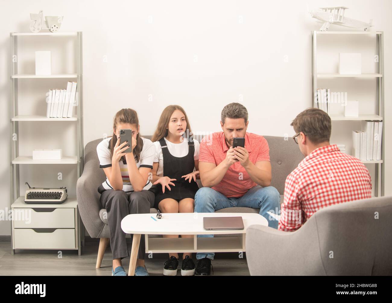 phone addicted father mother and child at family psychologist, therapy ...