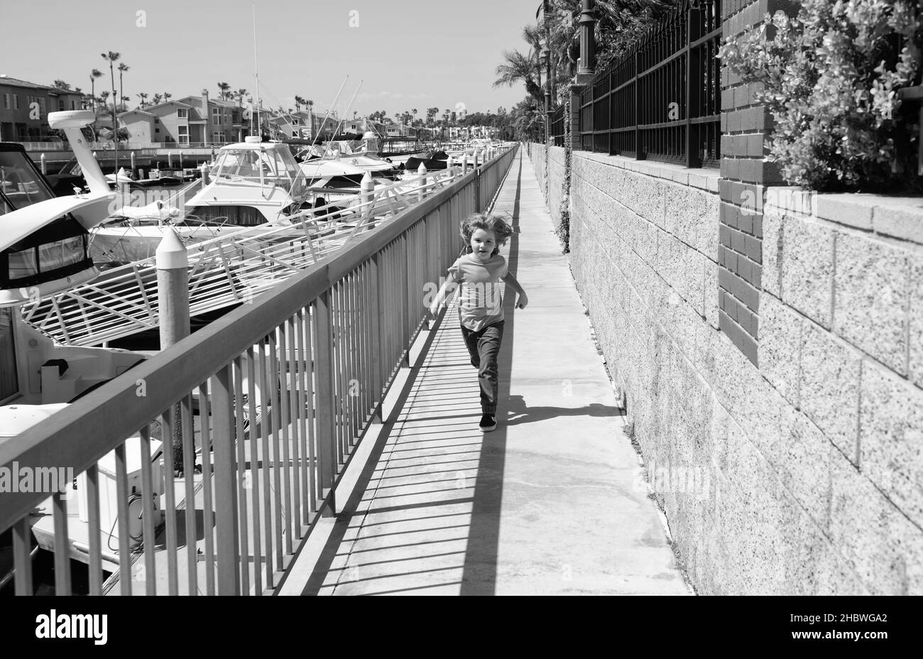 Summer activity. Active boy run on promenade. Activity holidays ...