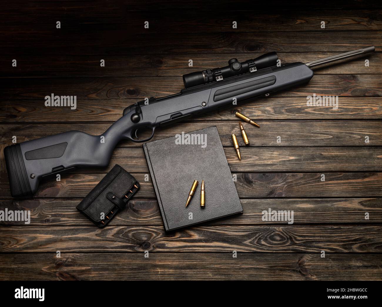 A modern bolt-action scout rifle with a telescopic sight. Weapon on a ...