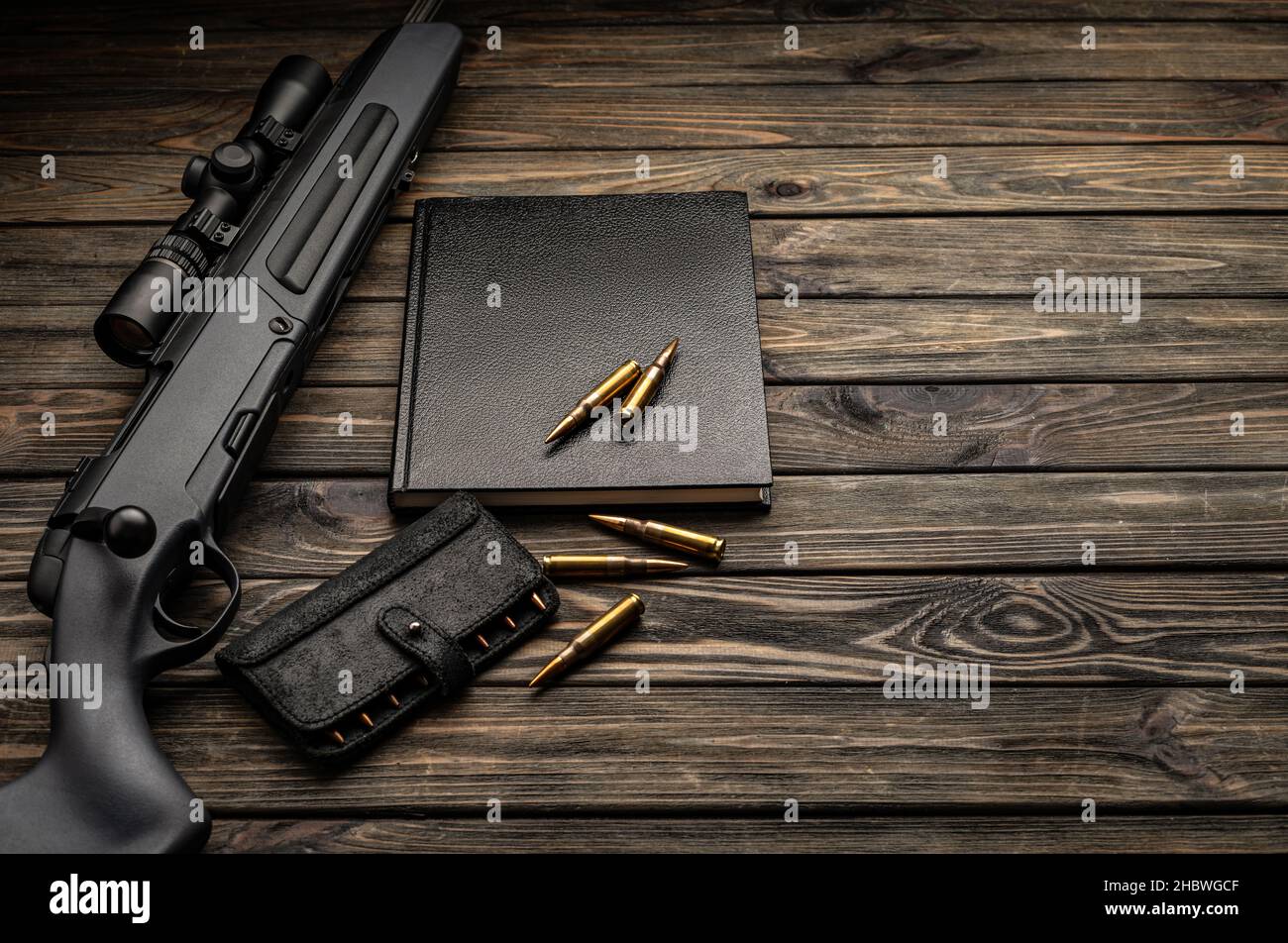 A modern bolt-action scout rifle with a telescopic sight. Weapon on a ...