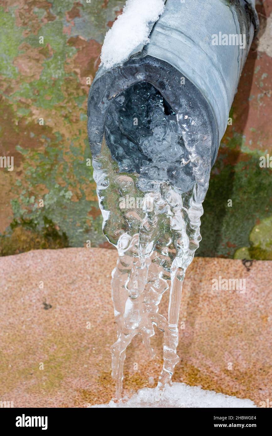 Large ice in the rain gutter on the house Stock Photo - Alamy