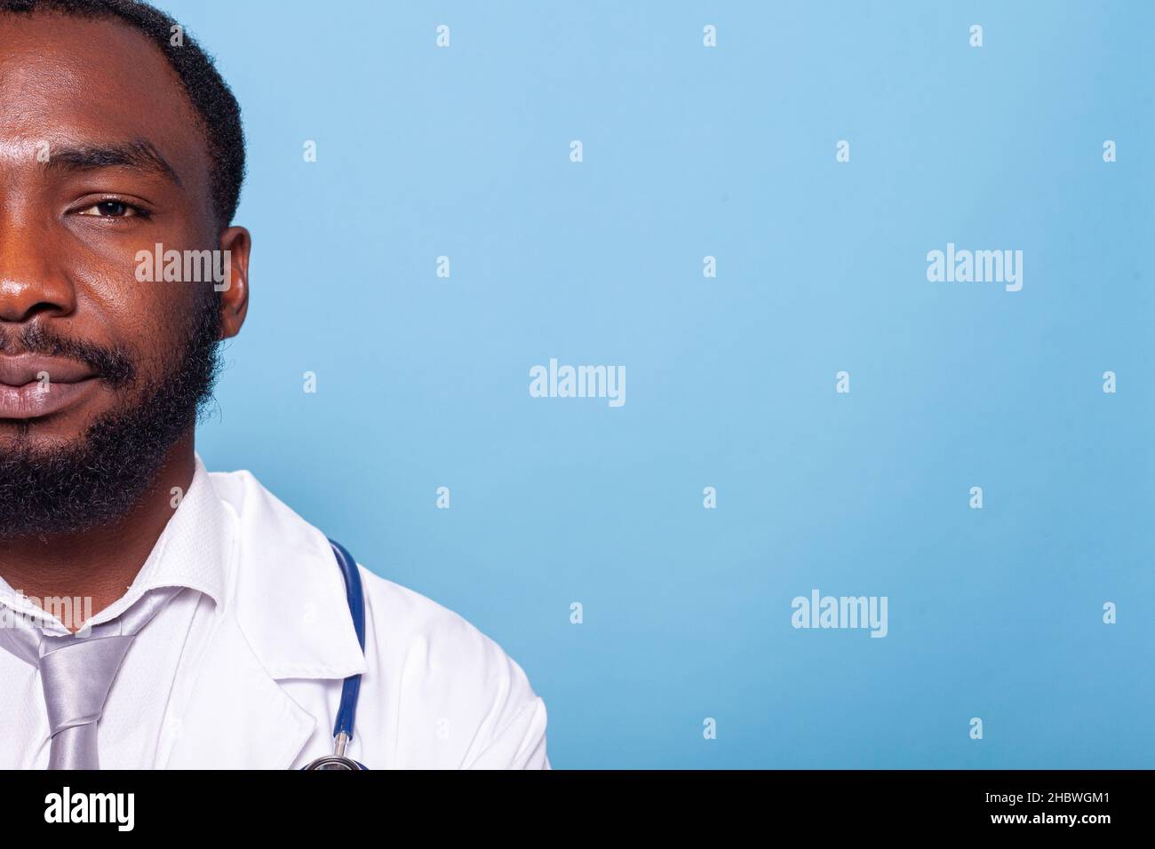 Half face closeup portrait of smiling medical doctor in white lab coat ...