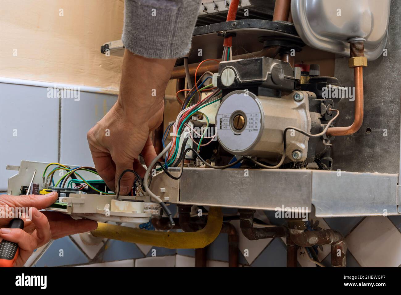 Professional setting up and servicing by heating systems installer in ...