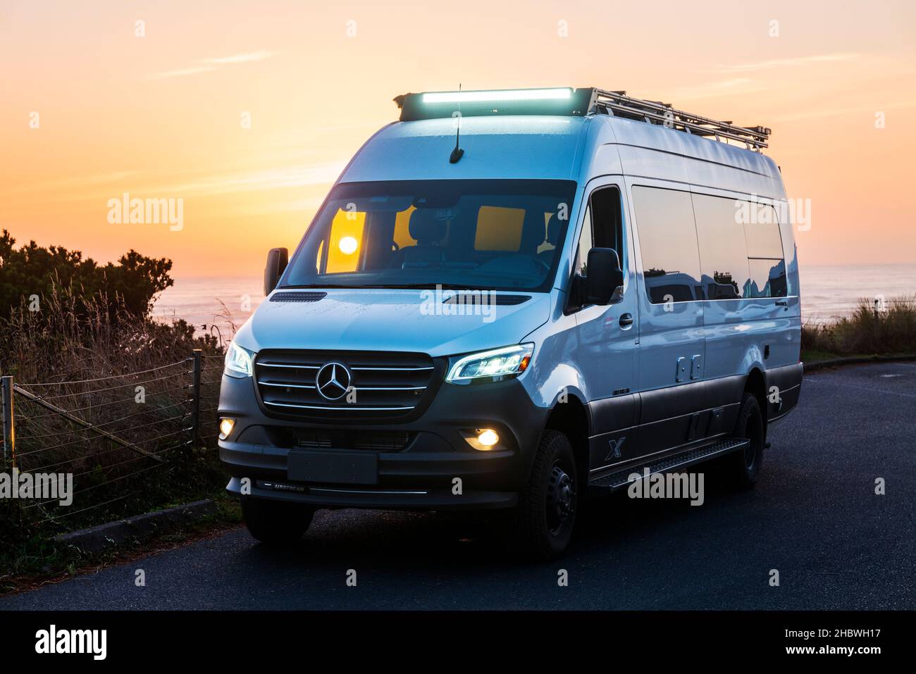 Airstream Interstate 24X 4WD; campervan; sunset over Pacific Ocean near ...